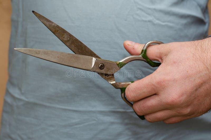 The Middle Section of the Man Holding the Old Open Scissors Stock Image ...