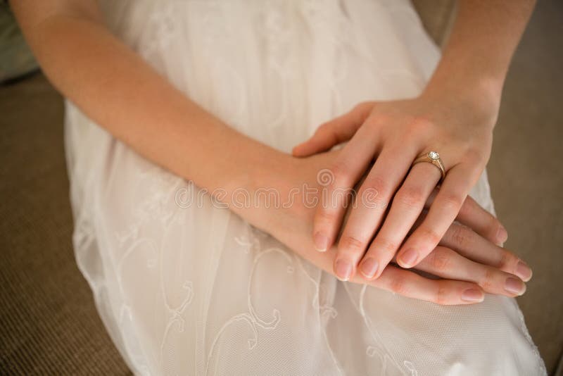 Midsection of Bride Wearing Wedding Ring while Sitting on Sofa Stock ...