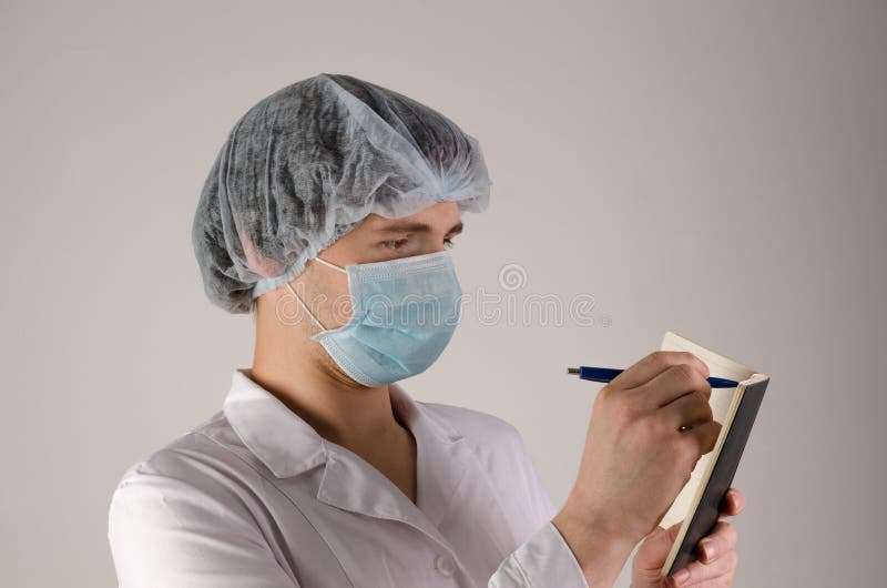 Midsection of Doctor Writing in Notepad at Clinic Stock Image - Image ...