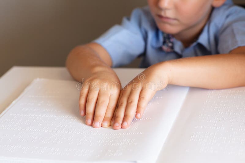 Midsection of Elementary Schoolboy with Hands on Braille at Desk in ...