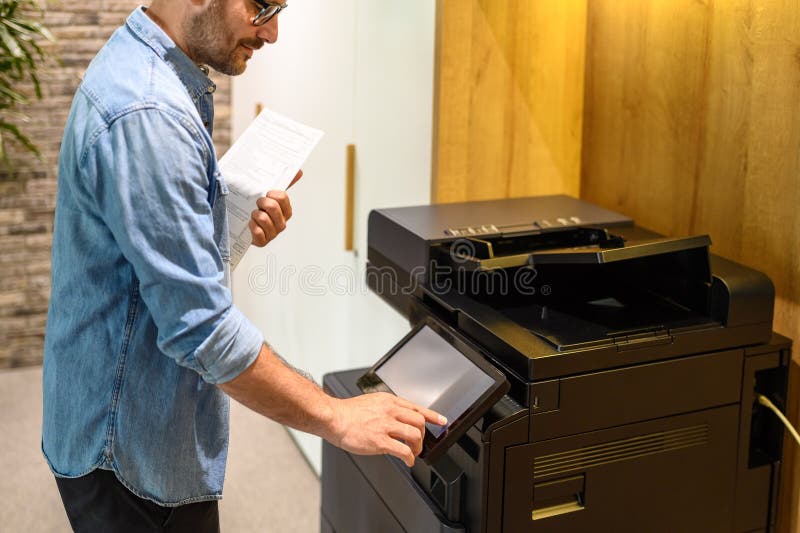 Midsection of Male Accountant Making Photocopies of Reports through ...