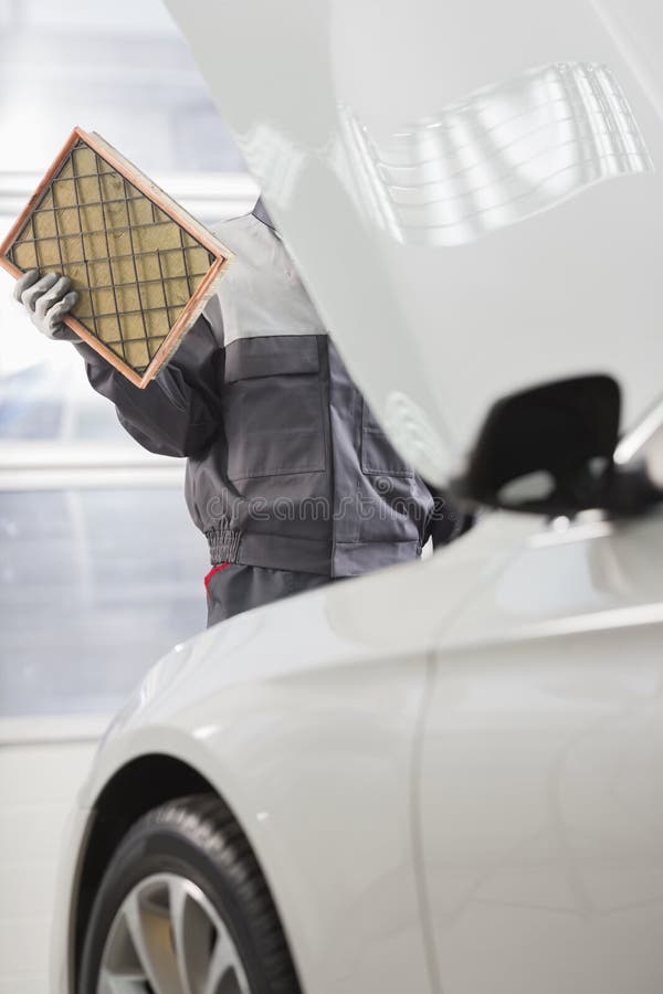 Midsection of Male Maintenance Engineer Repairing Car in Automobile ...