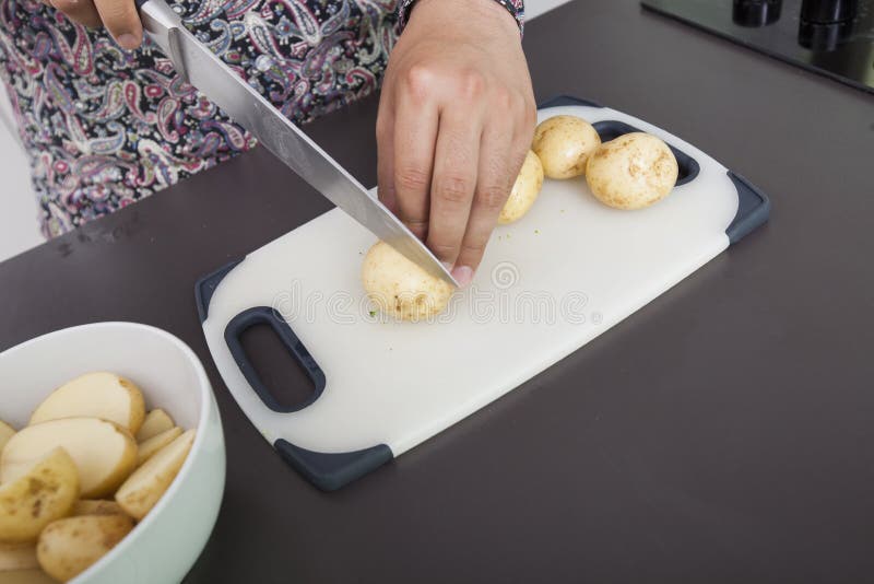 Midsection of Man Cutting Potato at Kitchen Counter Stock Image - Image ...