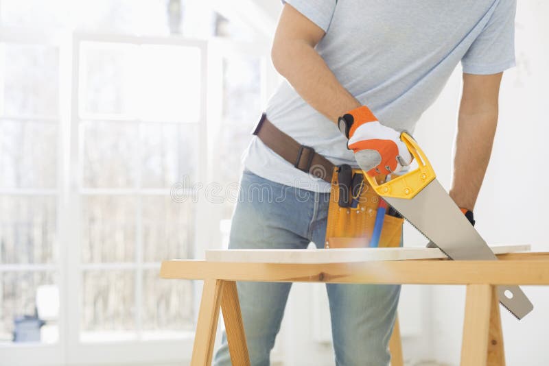 Midsection of Man Sawing Wood in New House Stock Photo - Image of ...