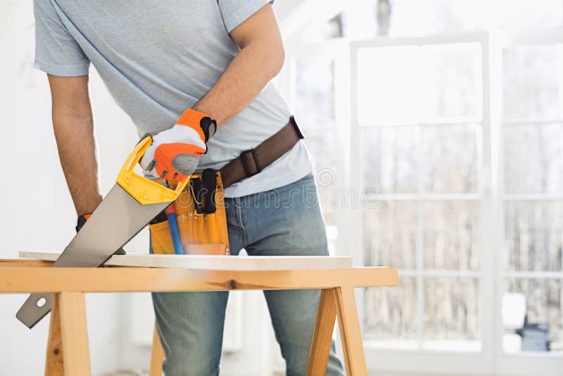 Midsection of Man Sawing Wood in New House Stock Image - Image of adult ...