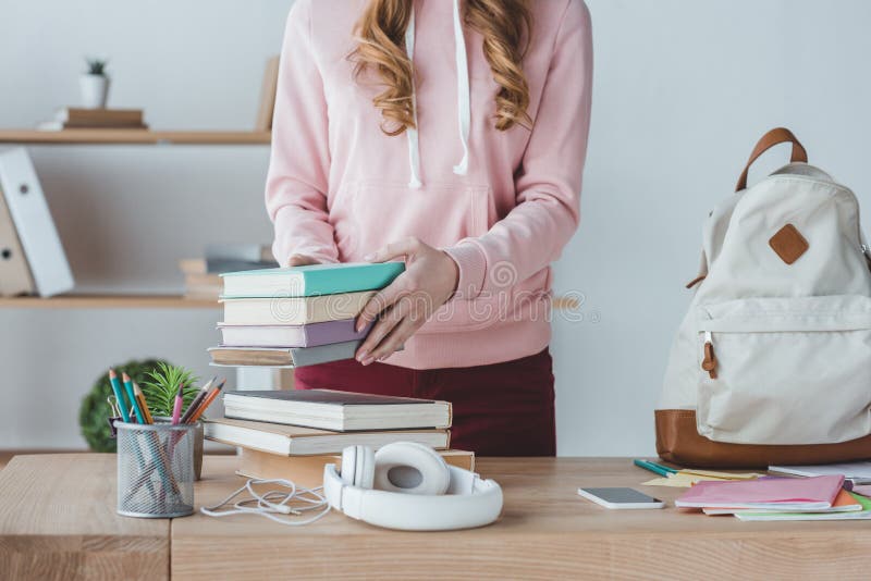 Midsection View of Female Student with Books and Backpack on Table ...