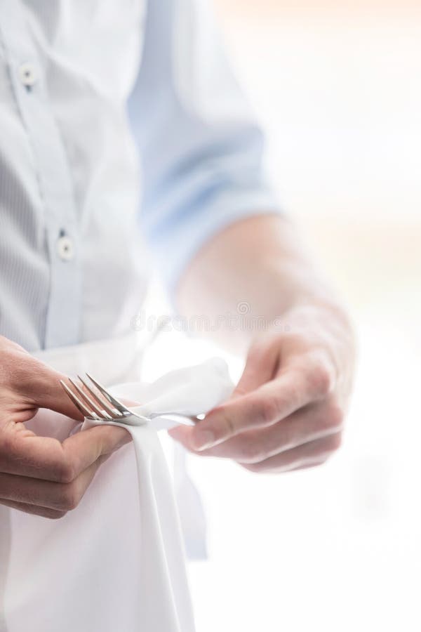 Midsection of Young Waiter Cleaning Fork in Restaurant Stock Image ...