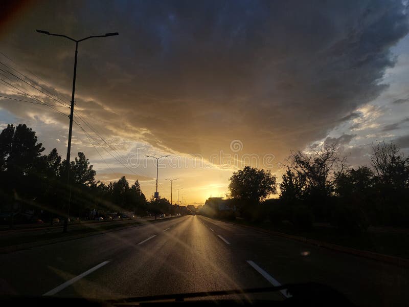 Midsummer Sunset from the Car with a View of the Road during a City ...