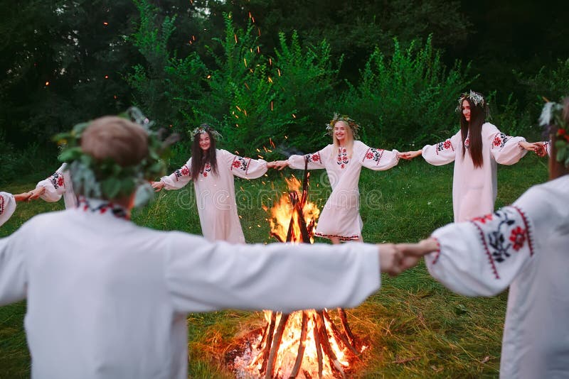 Midsummer. Two Girls in the Slavic Clothes Weave Braids in the Hair ...
