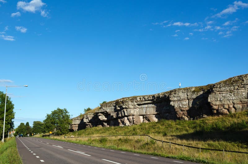 Mighty cliff by roadside stock photo. Image of sunny - 76730710