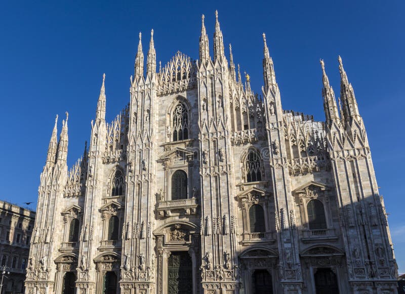 Milan Duomo under blue sky stock image. Image of evening - 83696675