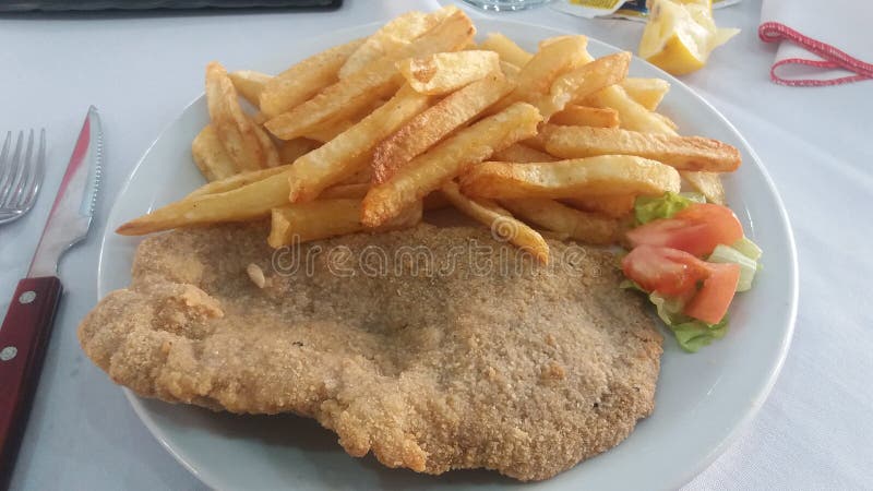Milanesa Dish with Fried Potatoes and Salad. Stock Image - Image of ...