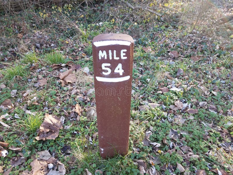 Mile Marker 54 or Post in Ground with Grass Stock Image - Image of mile ...