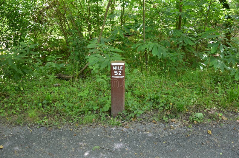 Mile Marker 52 Sign or Post and Green Plants Stock Photo - Image of ...