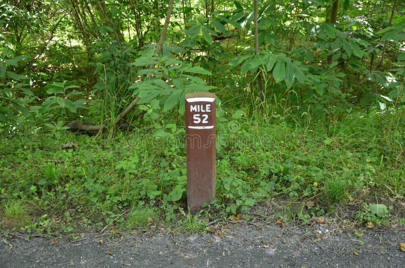 Mile Marker 52 Sign or Post and Green Plants Stock Photo - Image of ...
