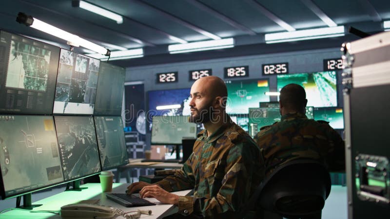 Portrait of Military Agent Working in Control Room, Analyzing Aerial ...