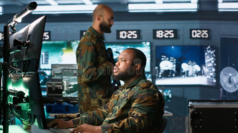 Intelligence Corps Agent Checking Screens, Discussing with Colleague ...