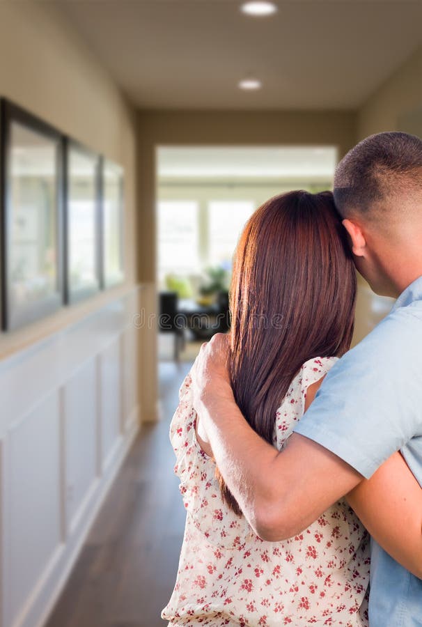Military Couple Looking Down the Hallway of New House Stock Photo ...