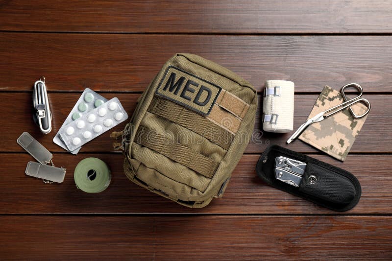 Military First Aid Kit on Wooden Table, Flat Lay Stock Image - Image of ...