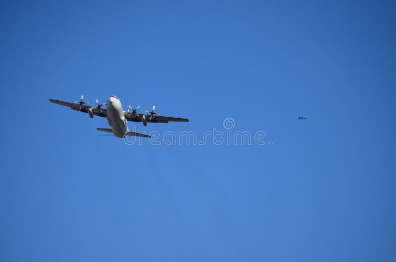 Military Four Helix Aircraft Flying with an Helicopter on the ...