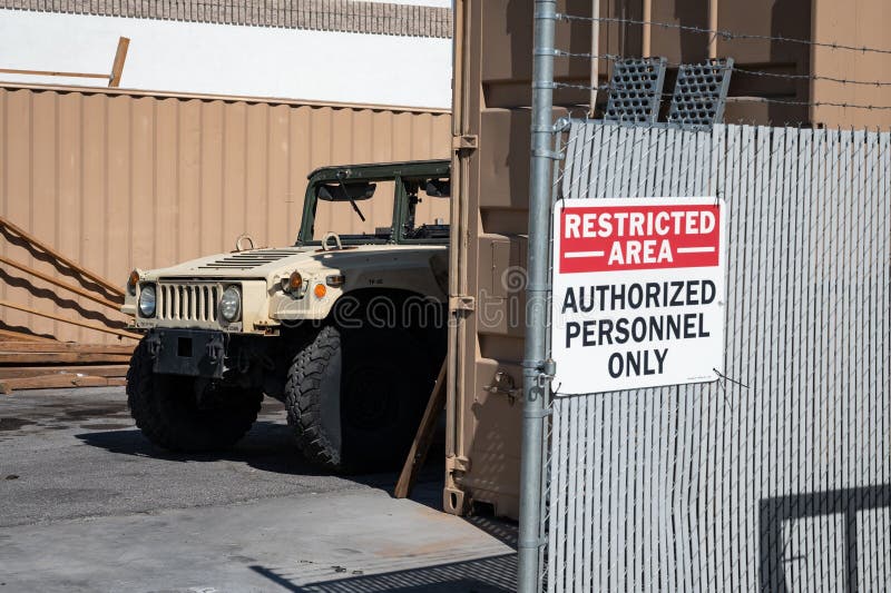 Military-grade Humvee Parked in Front of a Guarded Gate Editorial ...