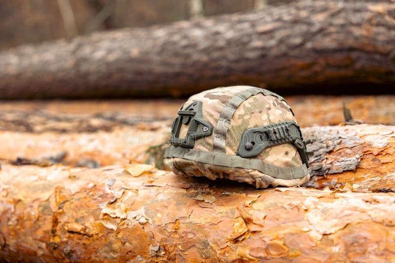 A Military Helmet Lies on a Felled Tree. Stock Photo - Image of outdoor ...