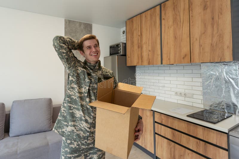Military man holding a box stock image. Image of cans - 295170193