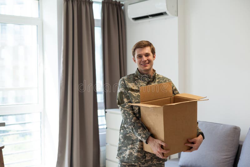 Military man holding a box stock photo. Image of holding - 295927924