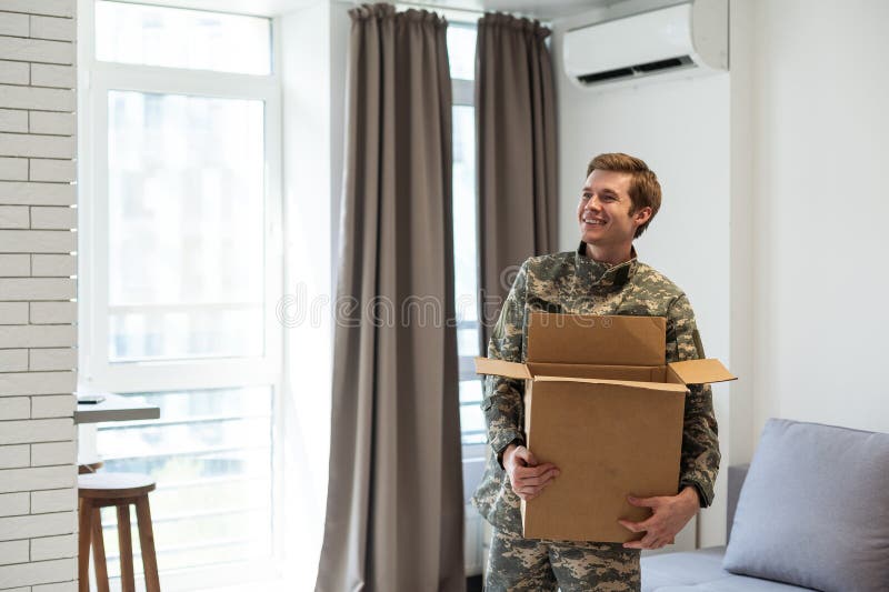 Military man holding a box stock photo. Image of food - 326215112