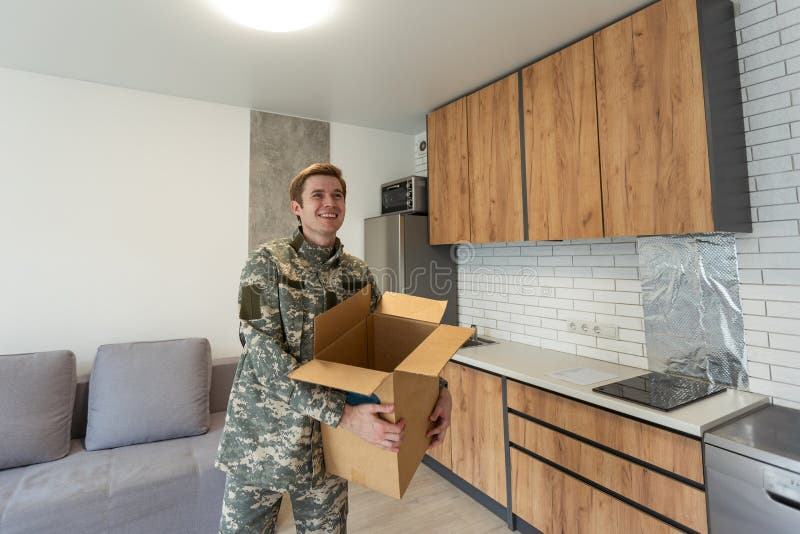 Military man holding a box stock image. Image of duty - 328965415