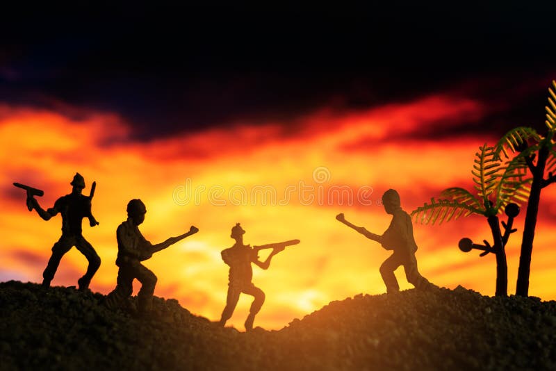 The Military Model is Fighting on the Sand Pile with the Sunset Behind ...