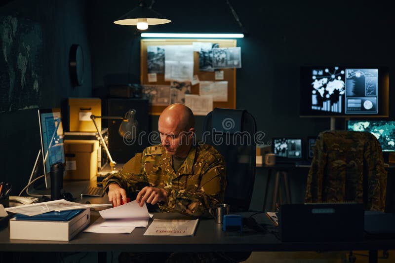 Military Personnel Analyzing Documents in Office Setting Stock Photo ...