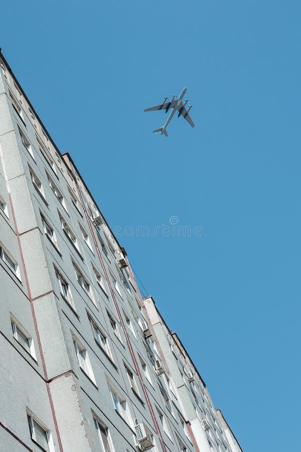 Military Plane Flying Overhead and Over a House in the Blue Sky Stock ...