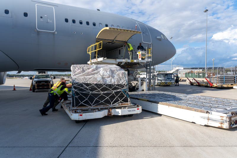 Military Plane Getting Loaded with Cargo by Workers Editorial ...