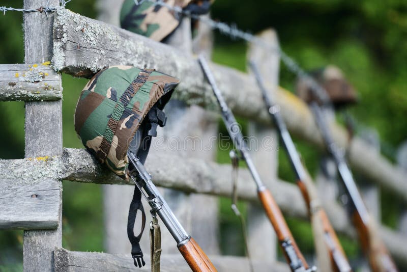 Military rifle and helmet stock photo. Image of grass - 29123538