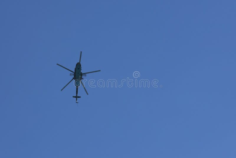 Military Russian Helicopter Flies in the Blue Sky. Bottom View Stock ...
