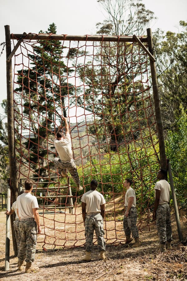 Military Soldier Climbing Rope during Obstacle Course Stock Photo ...