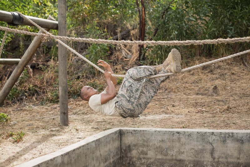 Military Soldier Climbing Rope during Obstacle Course Training Stock ...