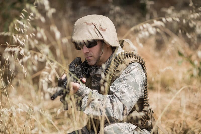 Military Soldier Hiding in Grass while Guarding with a Rifle Stock ...