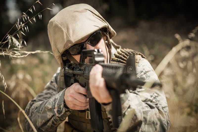 Military Soldier Hiding in Grass while Guarding with a Rifle Stock ...