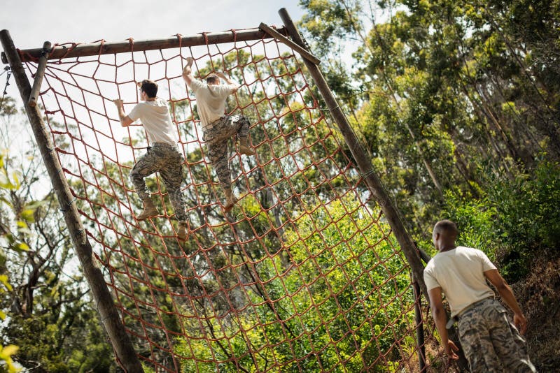 Military Soldiers Climbing Rope during Obstacle Course Stock Photo ...