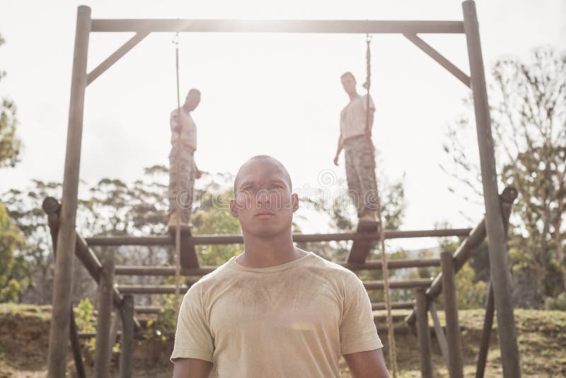 Military Man Standing With Arms Crossed During Obstacle Course In Boot ...