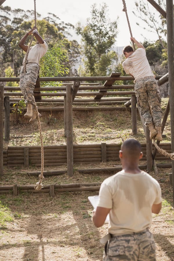 Military Soldiers Climbing Rope during Obstacle Course Training Stock ...