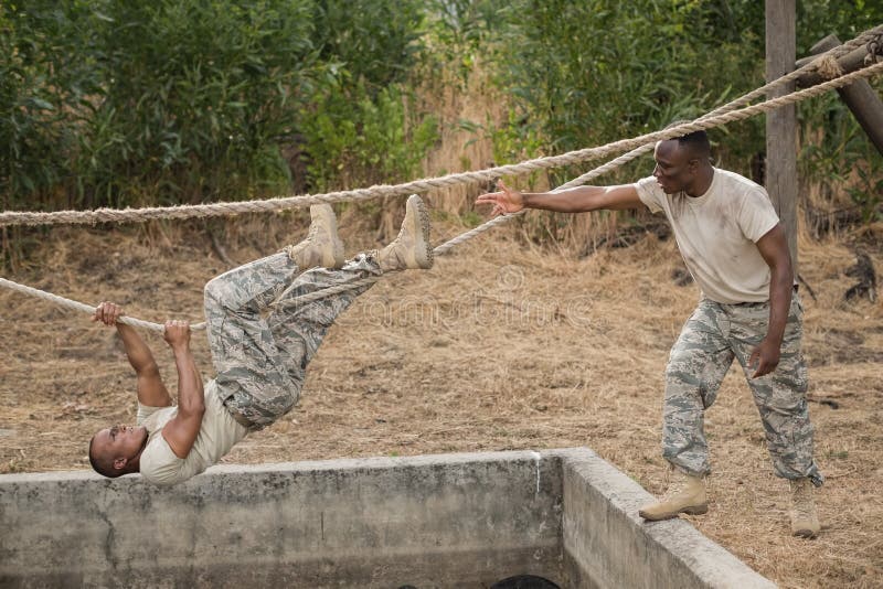 Military Soldiers Climbing Rope during Obstacle Course Training Stock ...