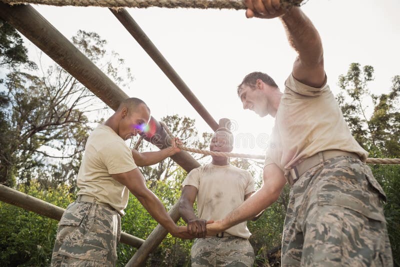 Military Soldiers with Hands Stacked during Obstacle Training Stock ...