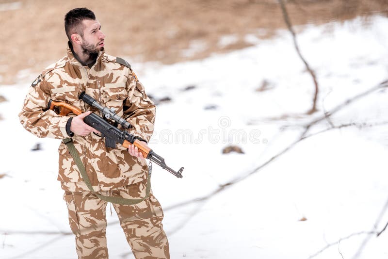 Military Trooper, Holding a Machine Gun on the Battlefield Stock Photo ...