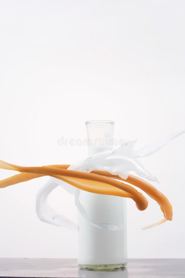 Milk Bottle with Milk Being Splashed with White and Chocolate Milk ...