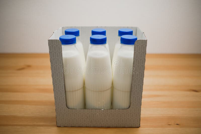 Milk Bottles in Cardboard Box on Wooden Table Stock Photo - Image of ...