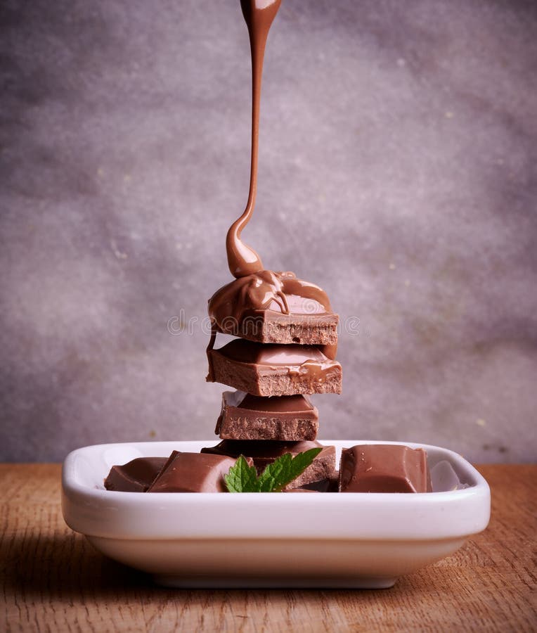 Milk Chocolate Pieces with Dripping Chocolate Stock Photo - Image of ...
