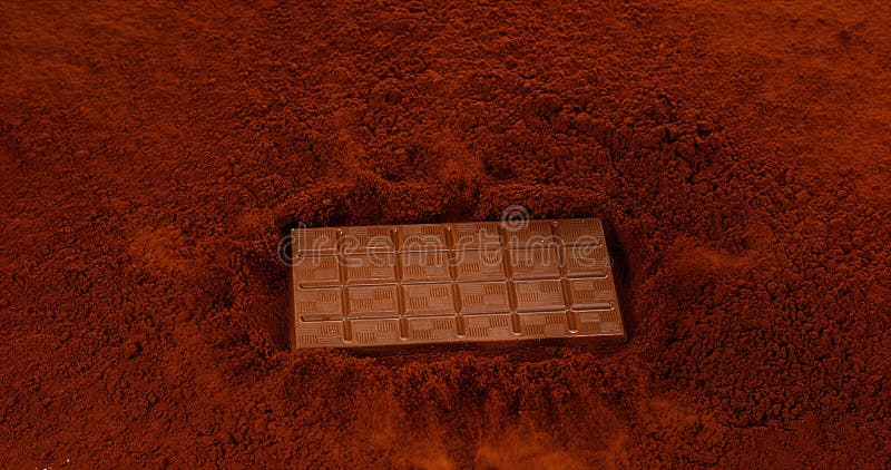 Milk Chocolate Tablet Falling on Black Chocolate Powder Stock Image ...